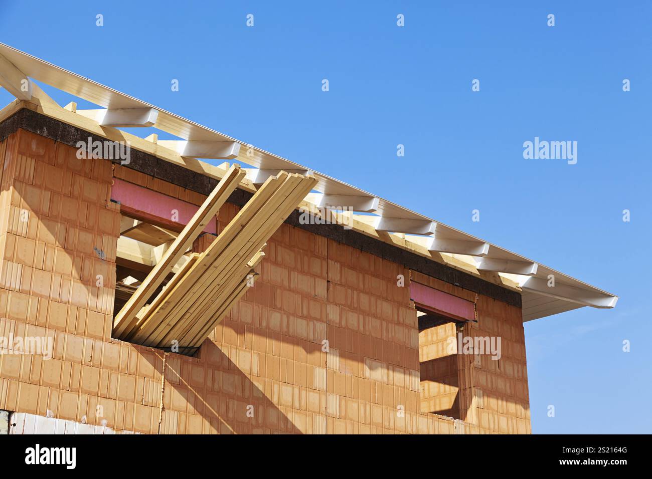 Shell construction on a building site of a residential house. Roof ...
