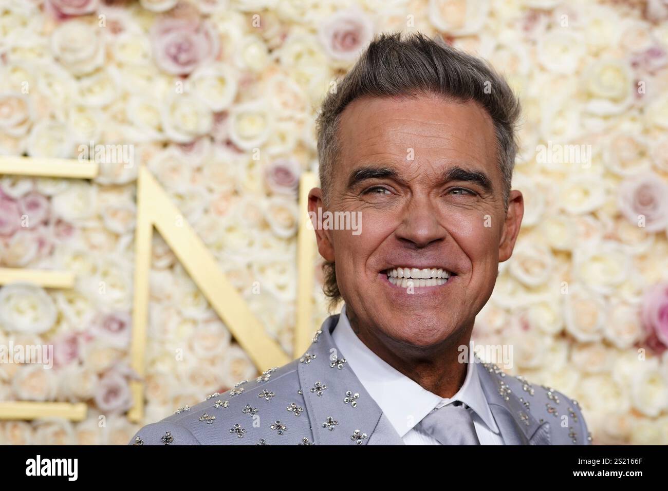 Robbie Williams arrives at the 82nd Golden Globes on Sunday, Jan. 5 ...