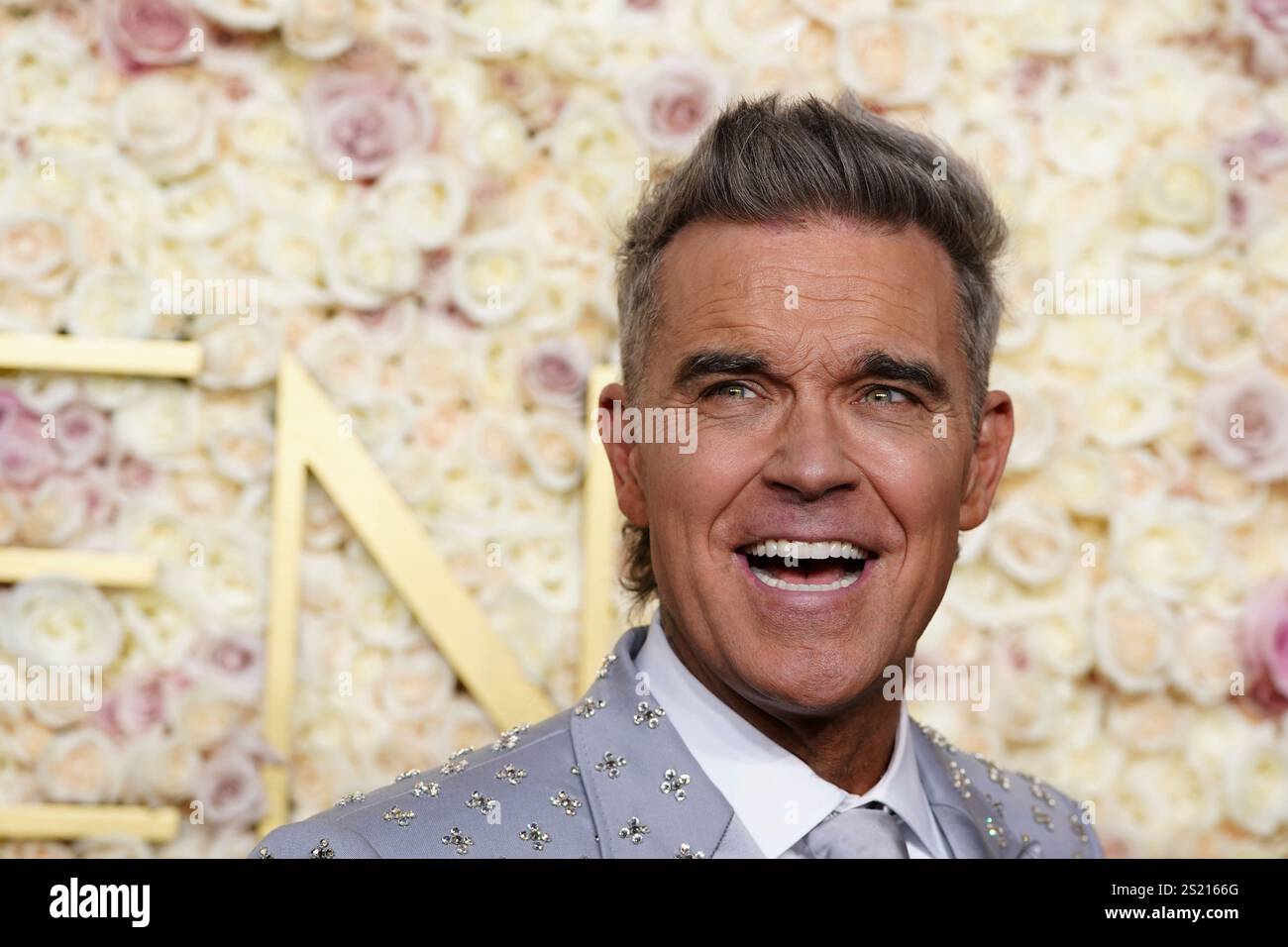 Robbie Williams arrives at the 82nd Golden Globes on Sunday, Jan. 5 ...