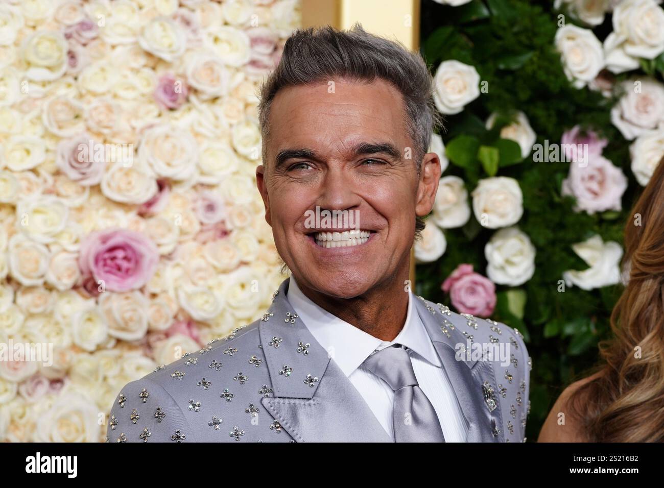 Robbie Williams arrives at the 82nd Golden Globes on Sunday, Jan. 5 ...