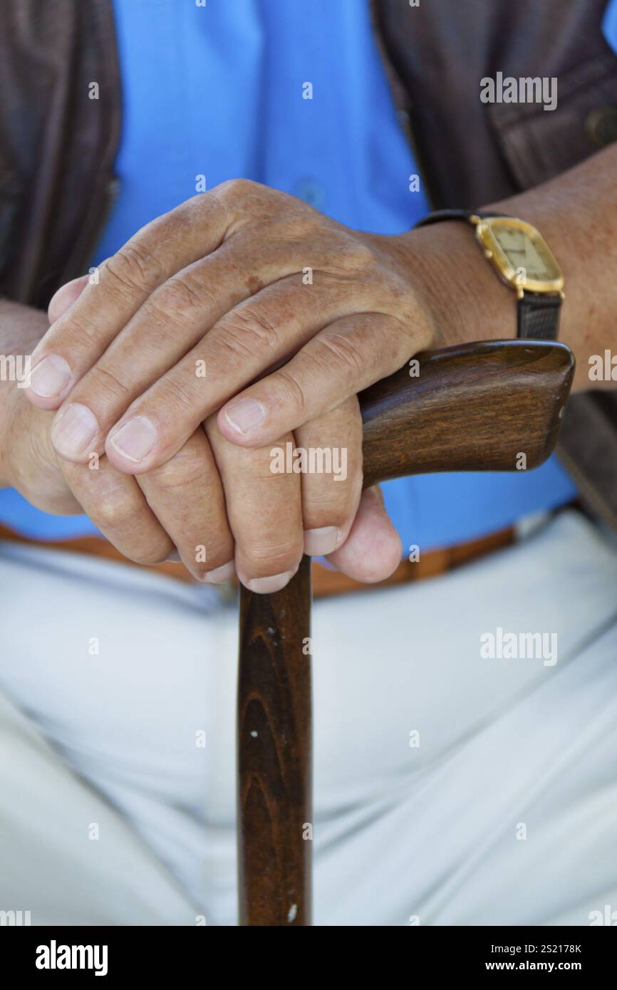 Hand of an elderly man with walking stick. Senior citizen with a ...