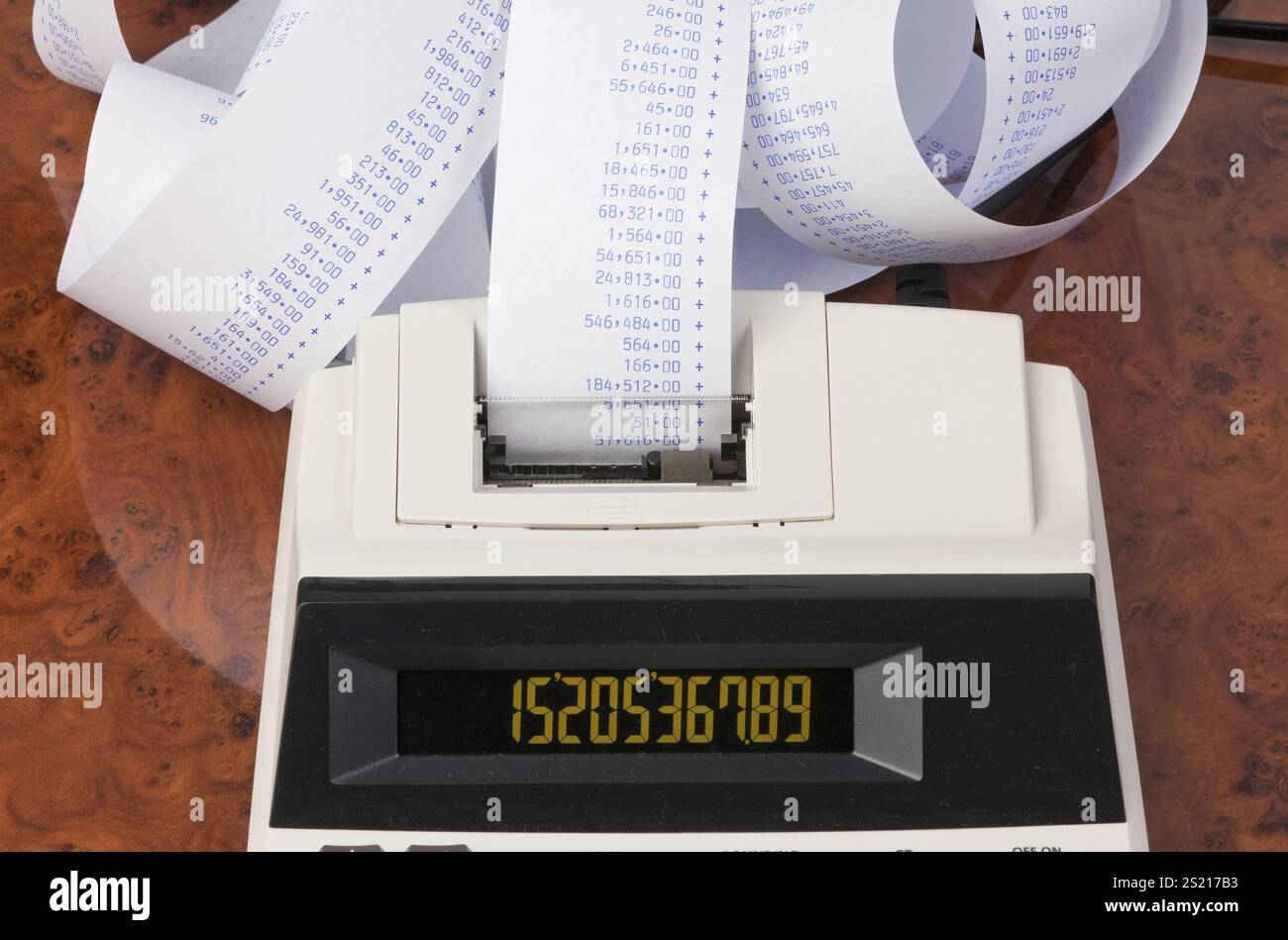 Desk calculator with calculator strip. Symbol for costs, expenses ...