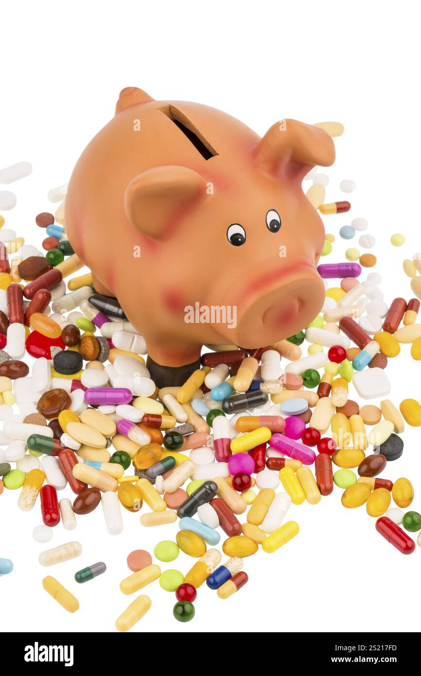 Tablets lying next to a piggy bank. Symbolic photo for costs in the ...