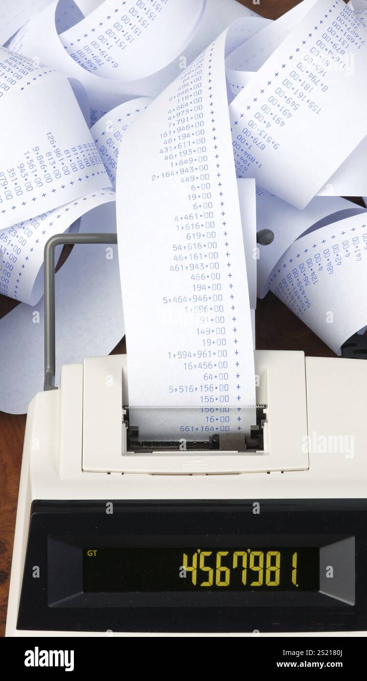 Desk calculator with calculator strip. Symbol for costs, expenses ...