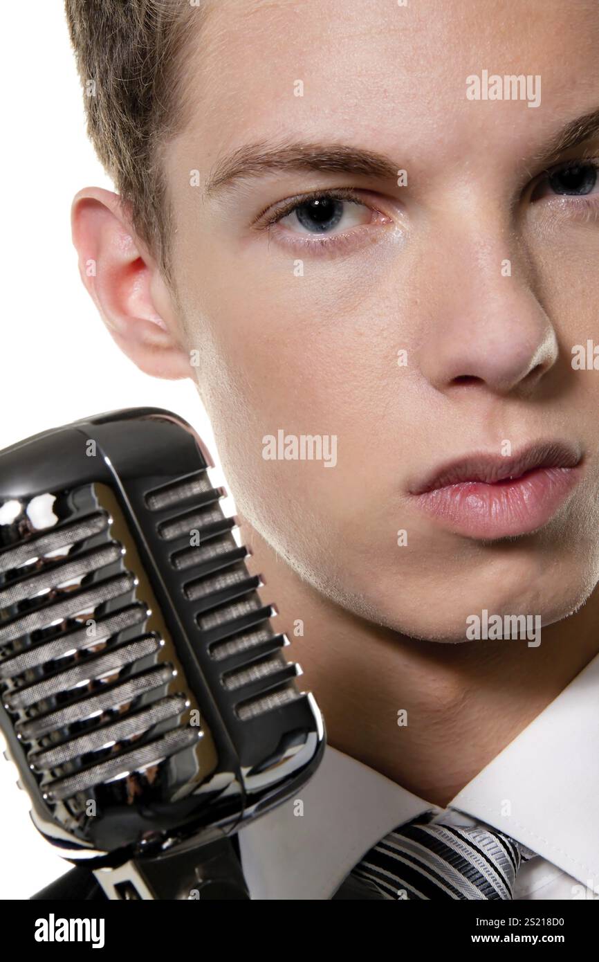 A young singer with a retro microphone sings karaoke Austria Stock ...