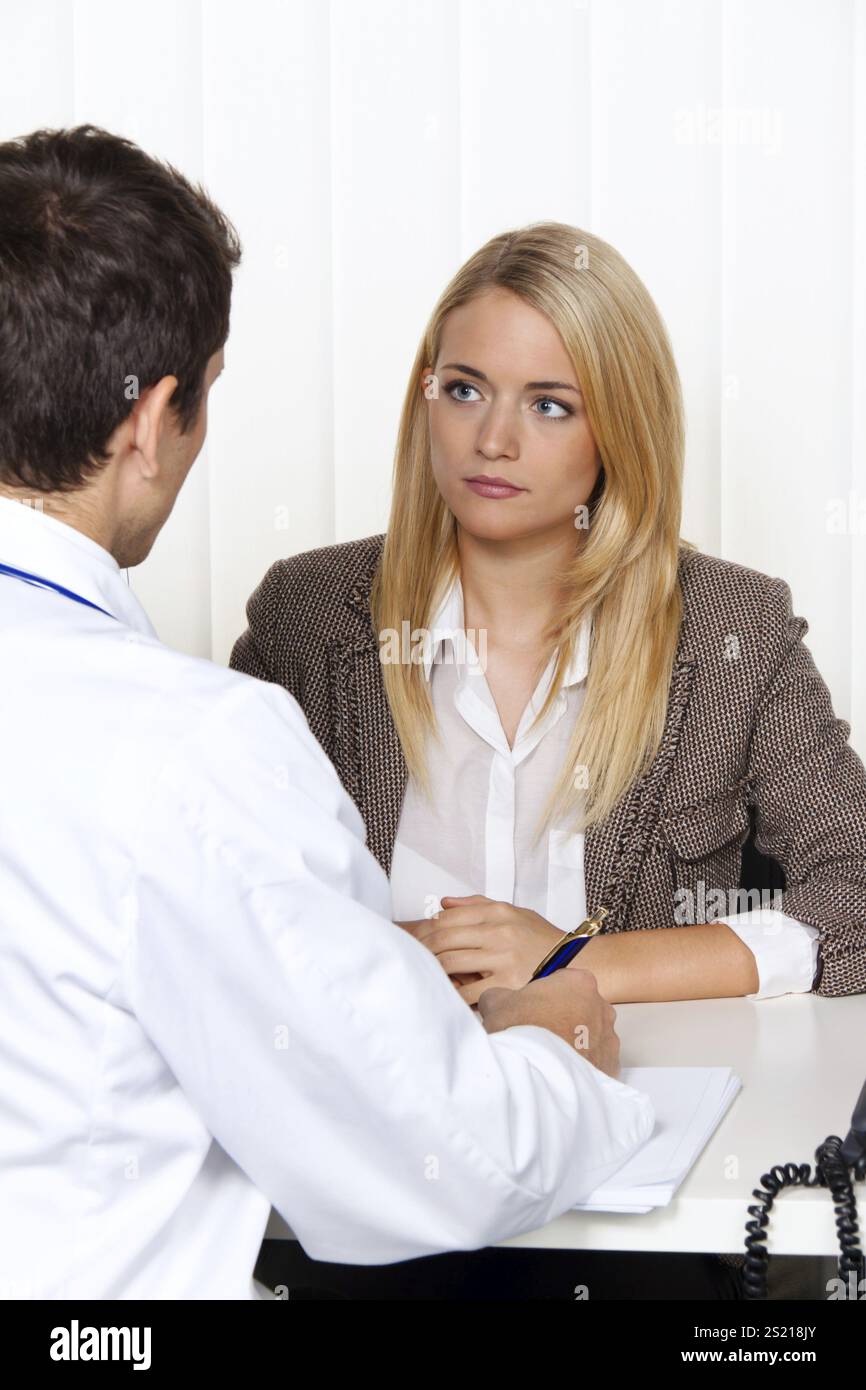 Conversation with a doctor. Patient and doctor talking in a doctor's ...