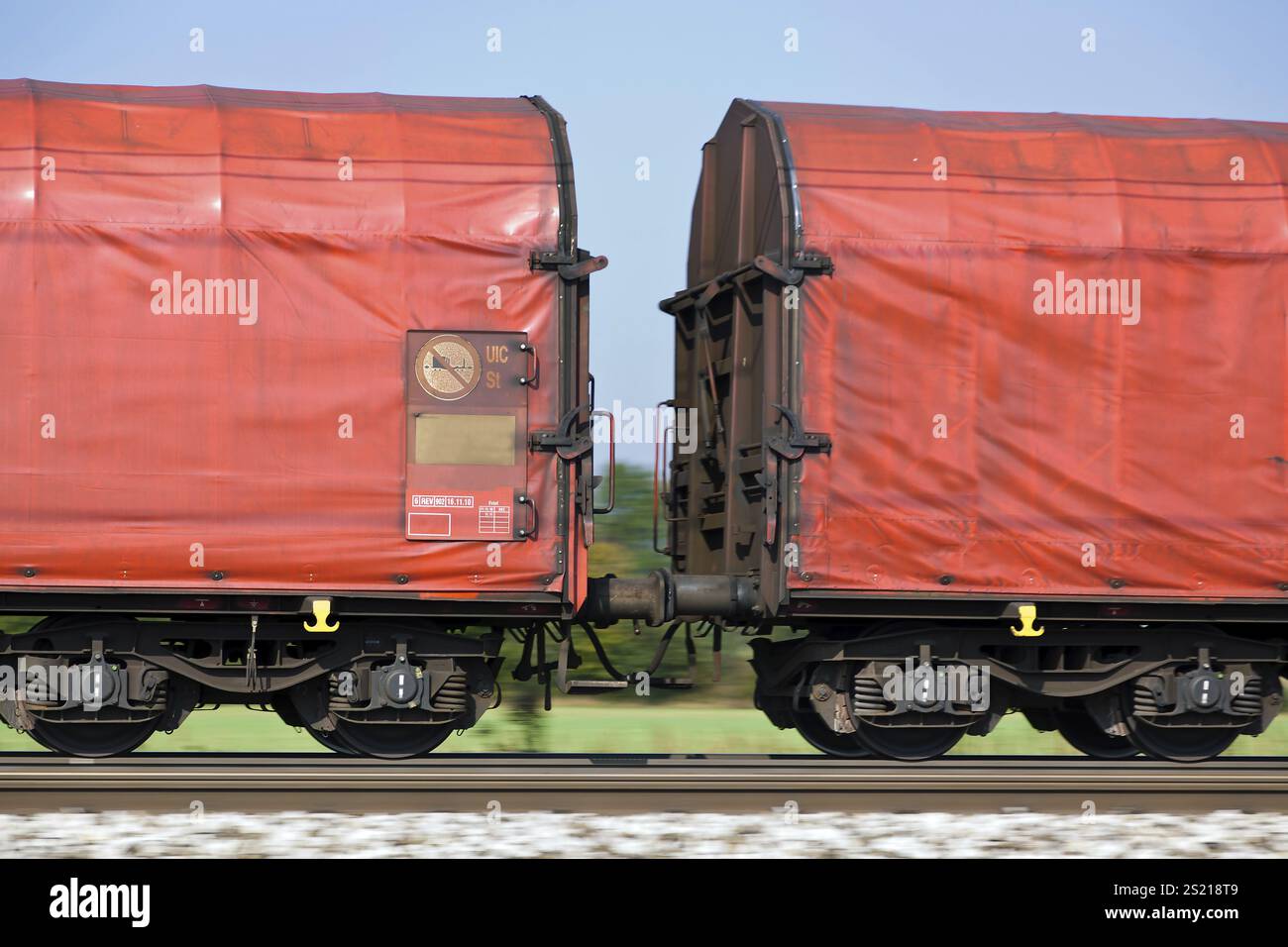 The wagons of a goods train on railway tracks. Environmentally friendly ...