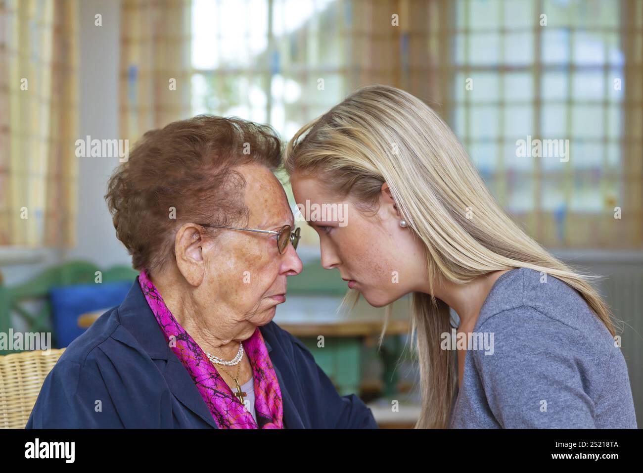 A grandson and his grandmother arguing. Conflict between generations ...
