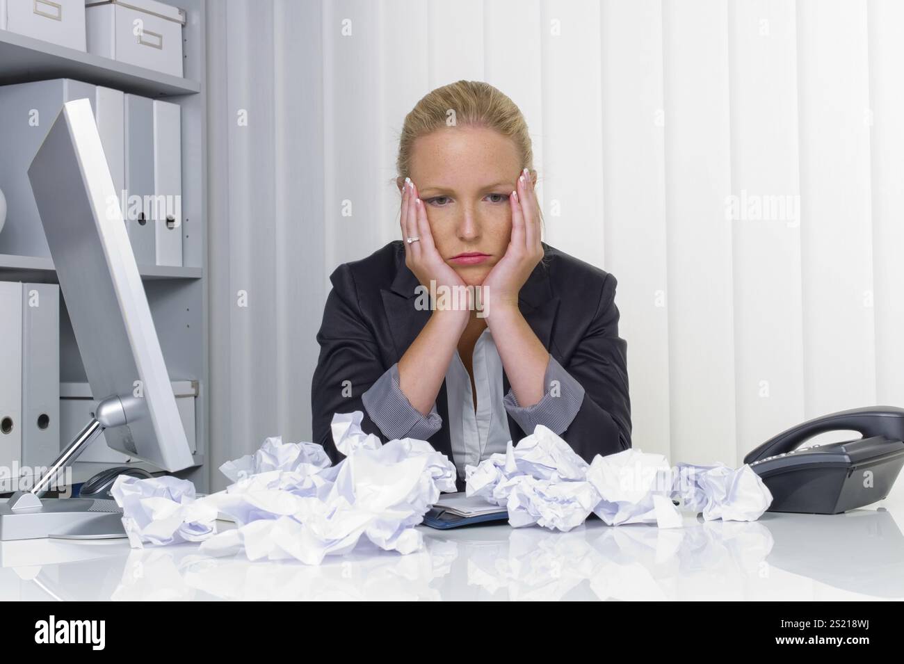 A woman in the office with a ball of paper. Anger, stress and ...