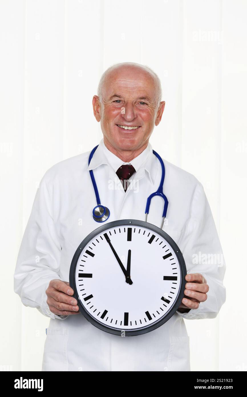 A doctor holds a watch. On the dial it is 5 minutes to 12 Austria Stock ...