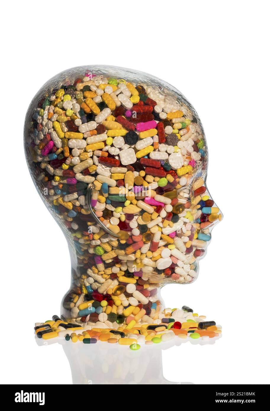 A glass head filled with many tablets. Symbolic photo for medication ...