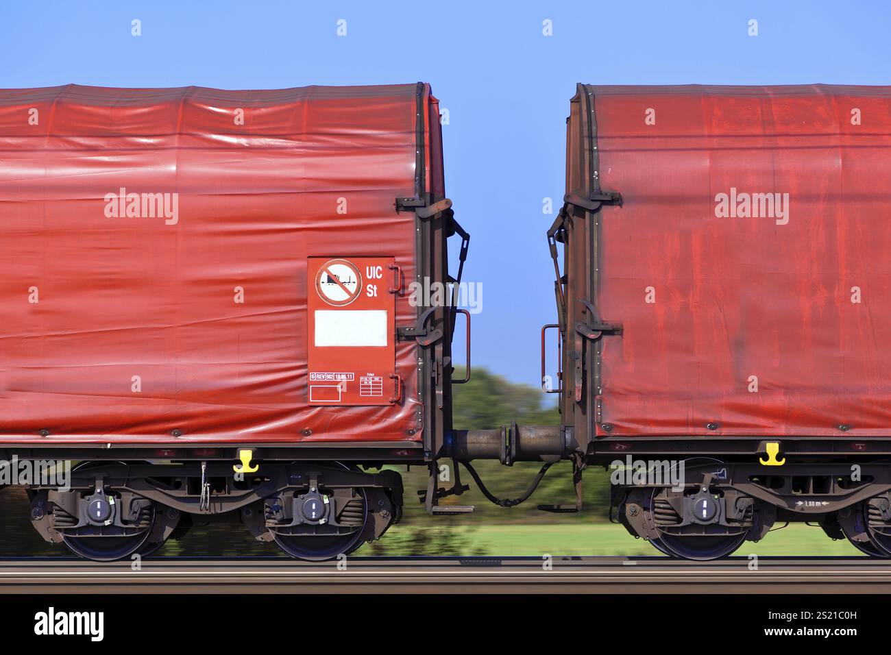 The wagons of a goods train on railway tracks. Environmentally friendly ...