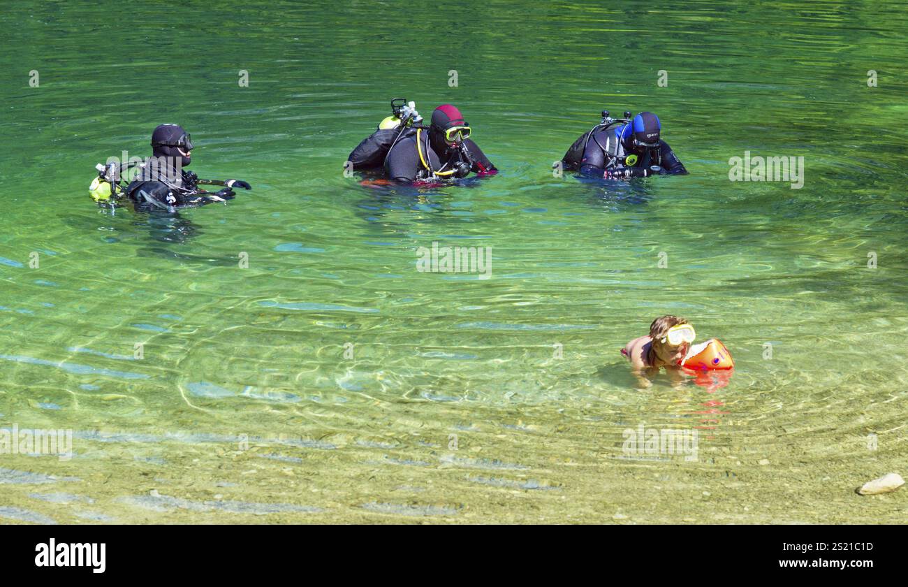 Divers get ready for a dive in a lake. Austria, Upper Austria ...