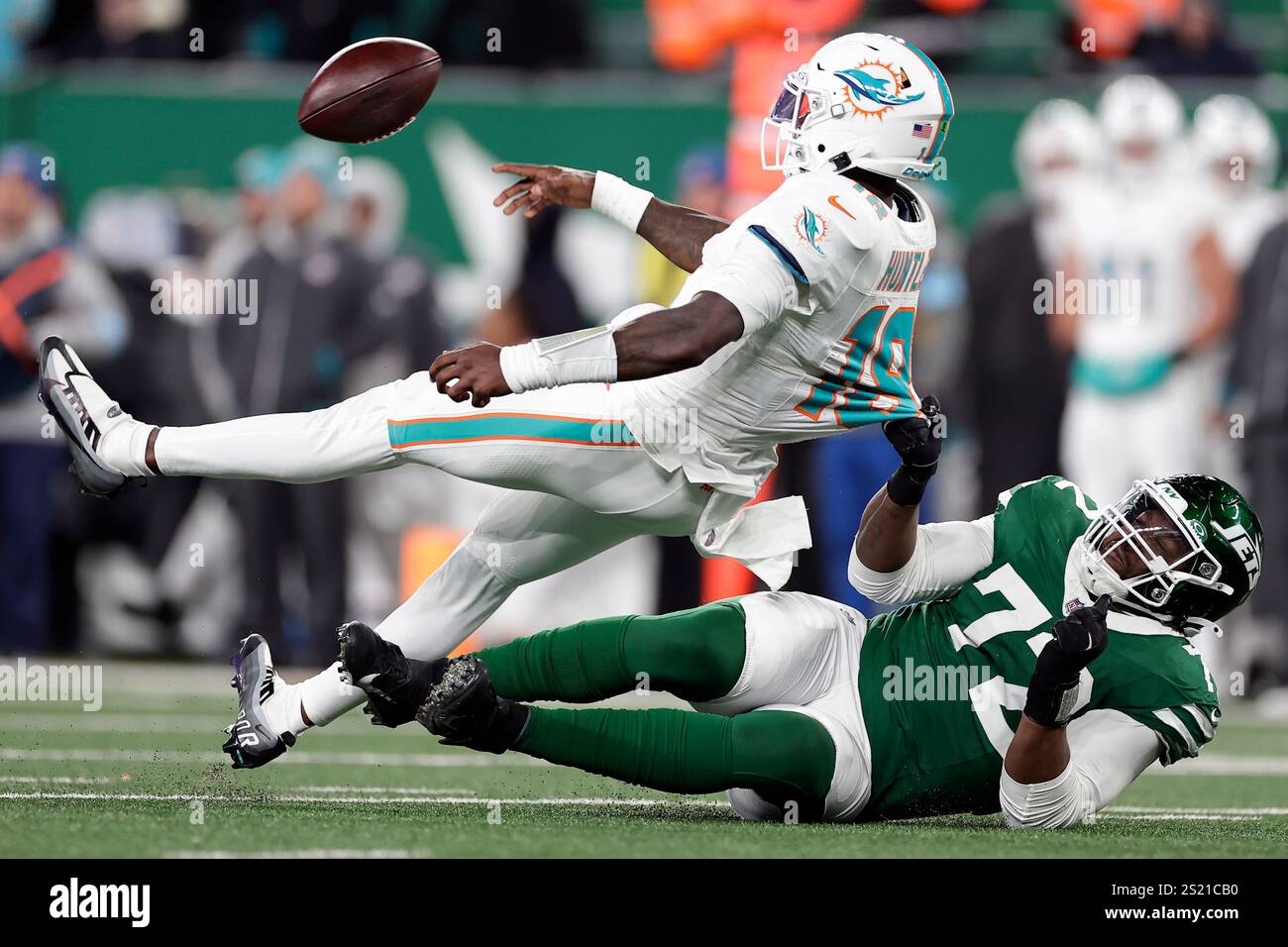 Miami Dolphins quarterback Tyler Huntley (18) throws the ball as he is ...