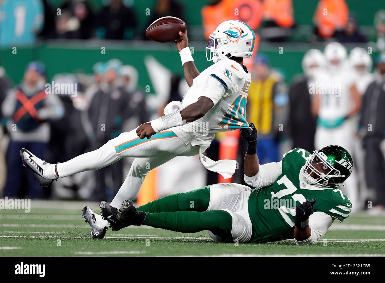 Miami Dolphins quarterback Tyler Huntley (18) throws the ball as he is ...