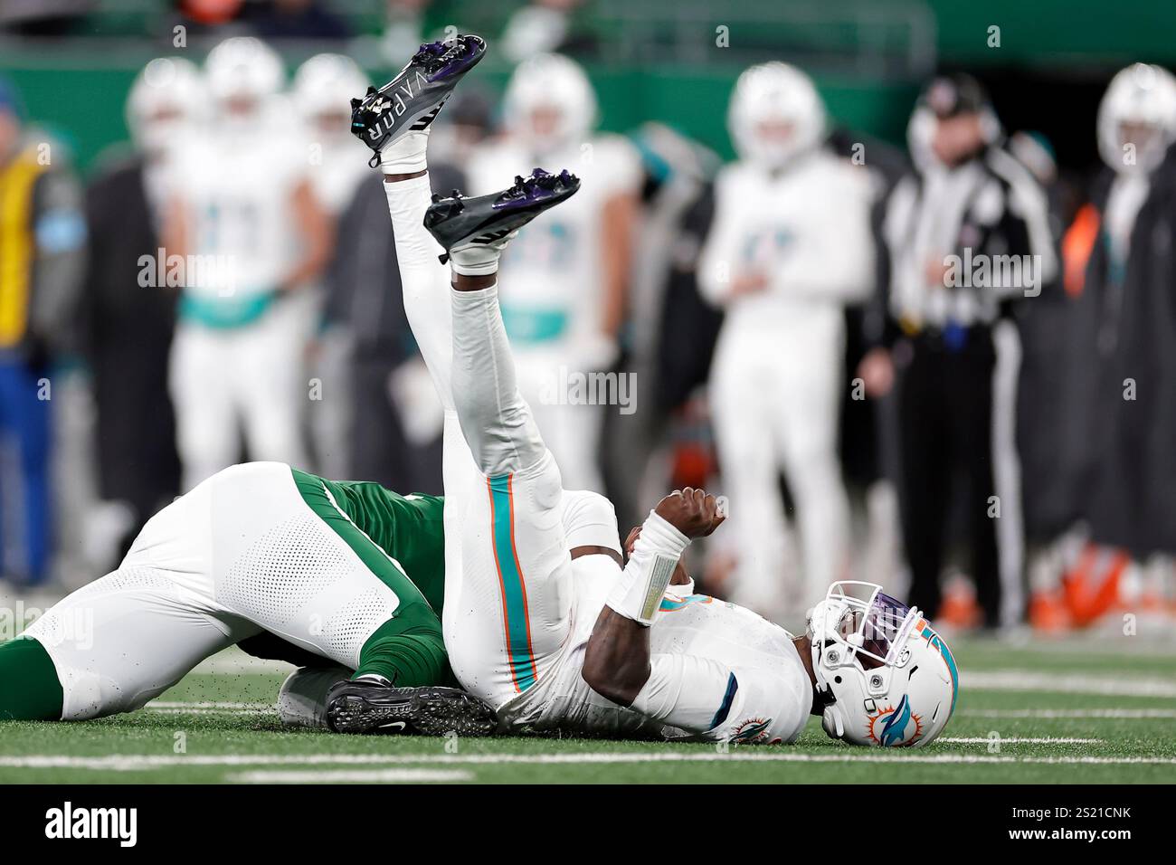 Miami Dolphins quarterback Tyler Huntley (18) hits the turf after being ...