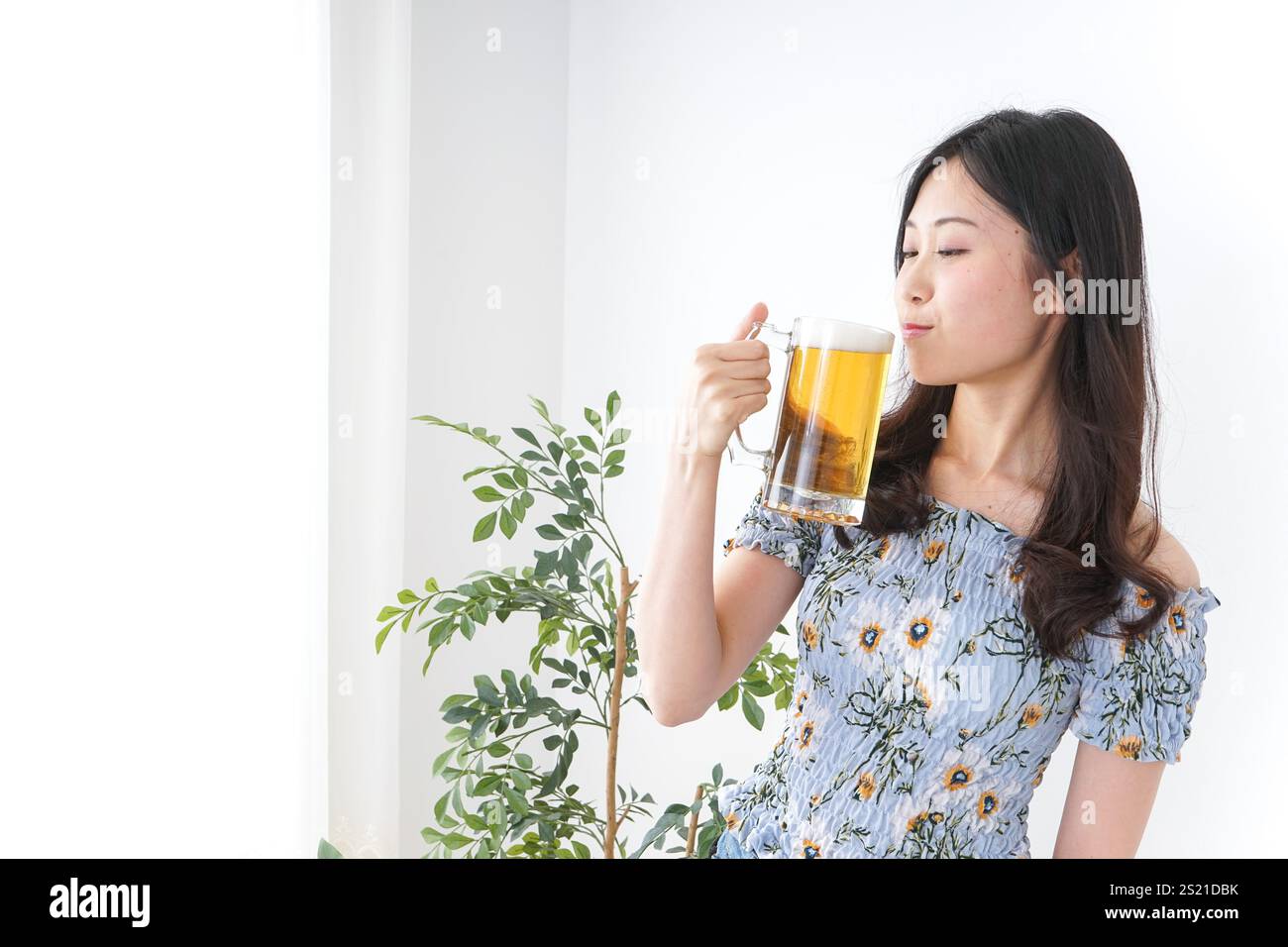 Woman drinking beer in beer garden Stock Photo - Alamy