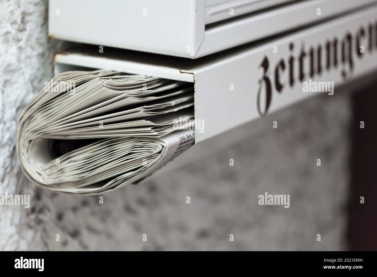 A newspaper was placed in a letterbox. Delivery of the daily newspaper ...