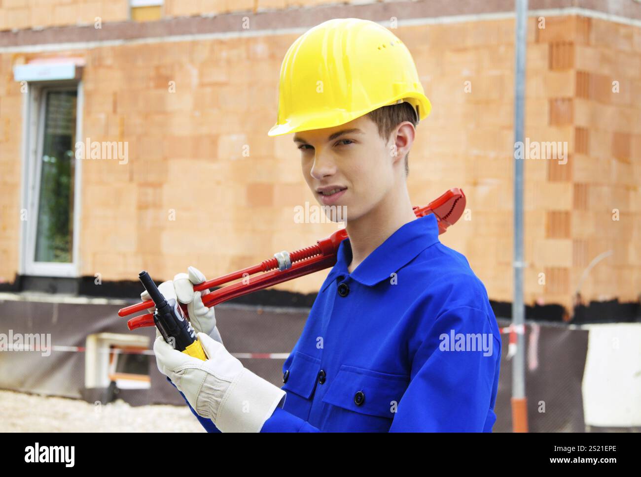 An apprentice / trainee. Construction worker on building site with ...