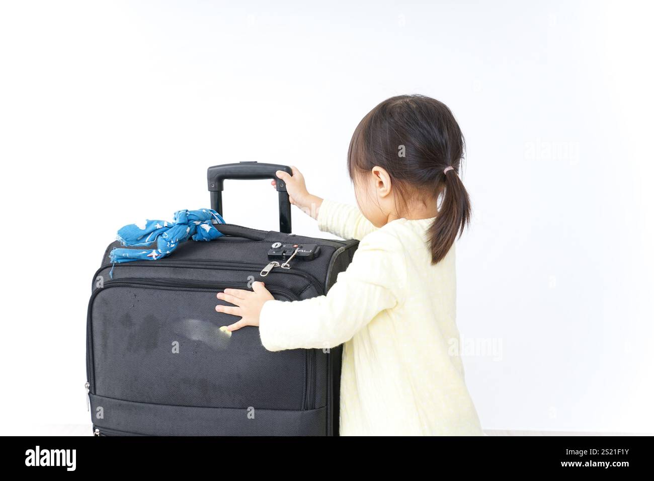 Child carrying a suitcase Stock Photo - Alamy