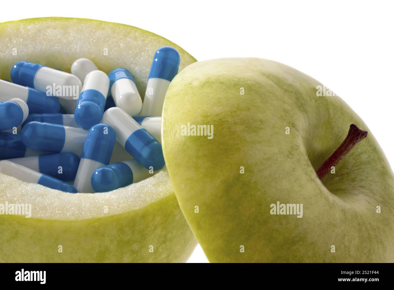 Apple with tablets capsules. Symbol photo for vitamin tablets Austria ...
