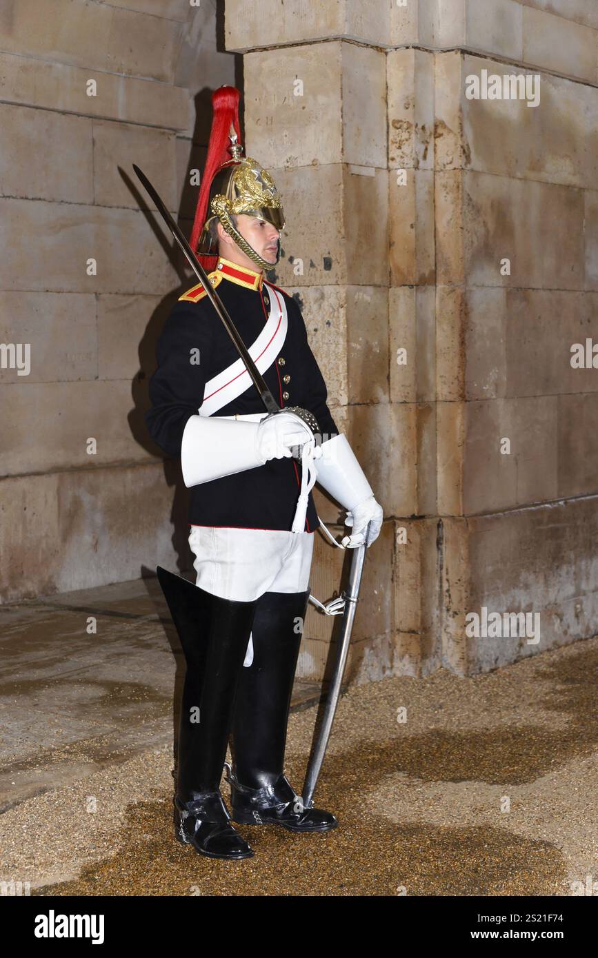 Security guard in traditional uniform in front of a stone arch in ...