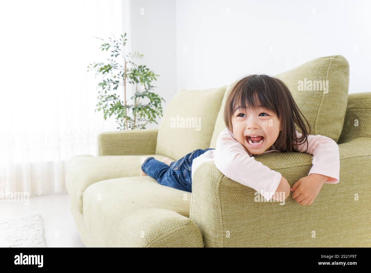 Child playing alone in room Stock Photo - Alamy