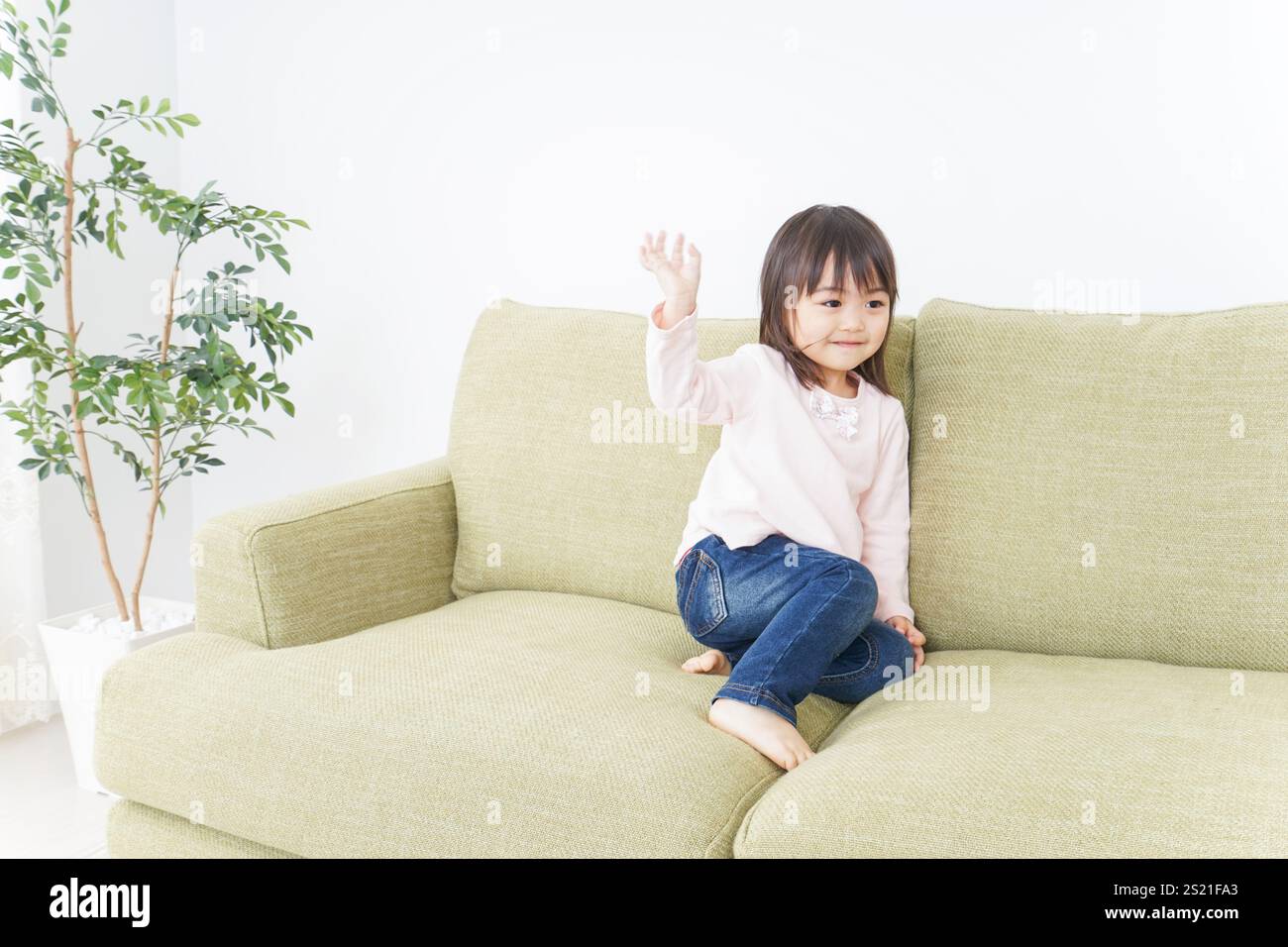Child playing alone in room Stock Photo - Alamy