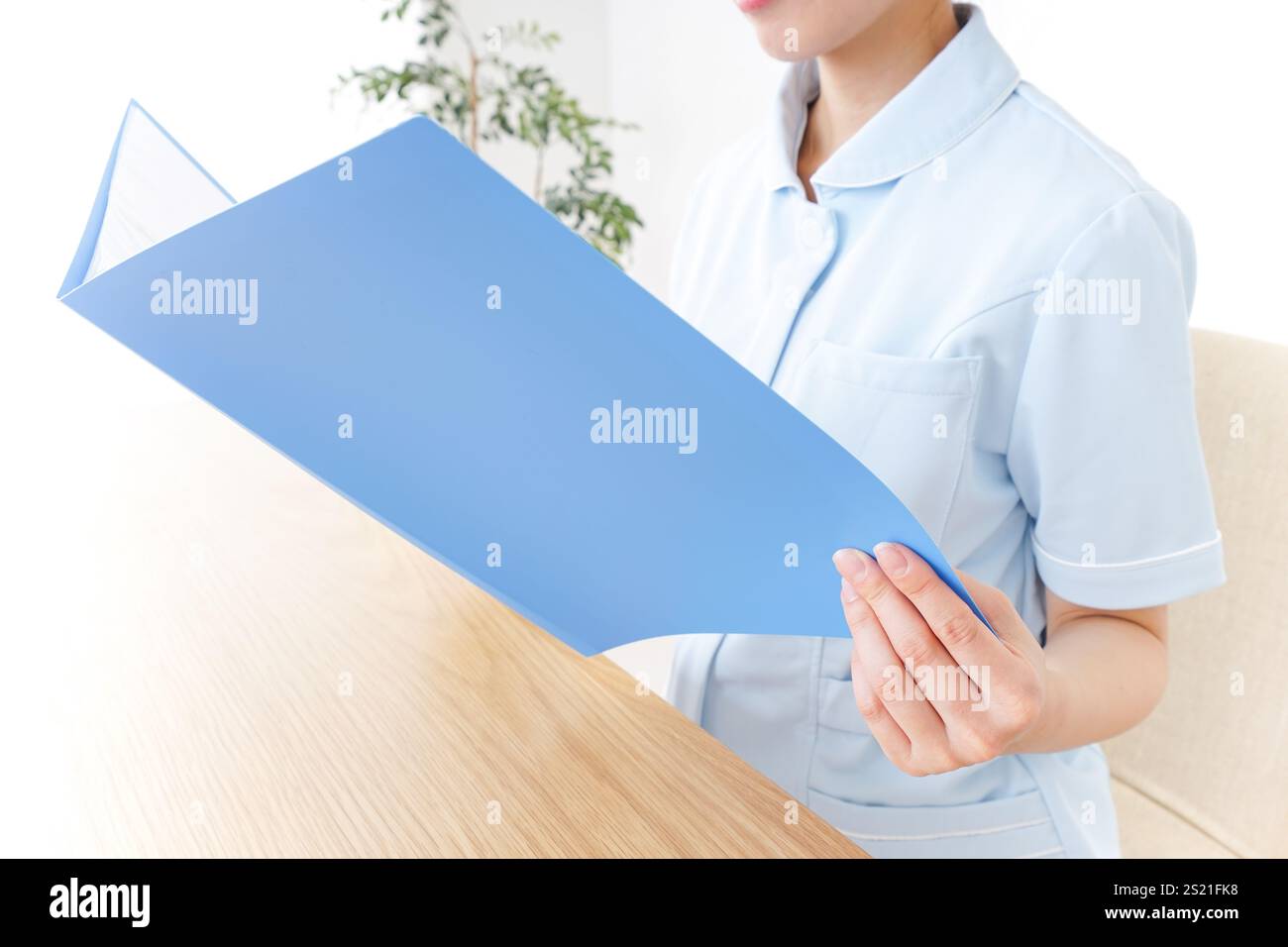 Nurse reading papers Stock Photo - Alamy