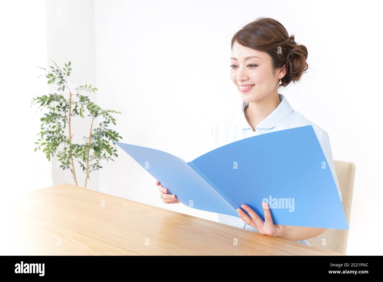 Nurse reading papers Stock Photo - Alamy
