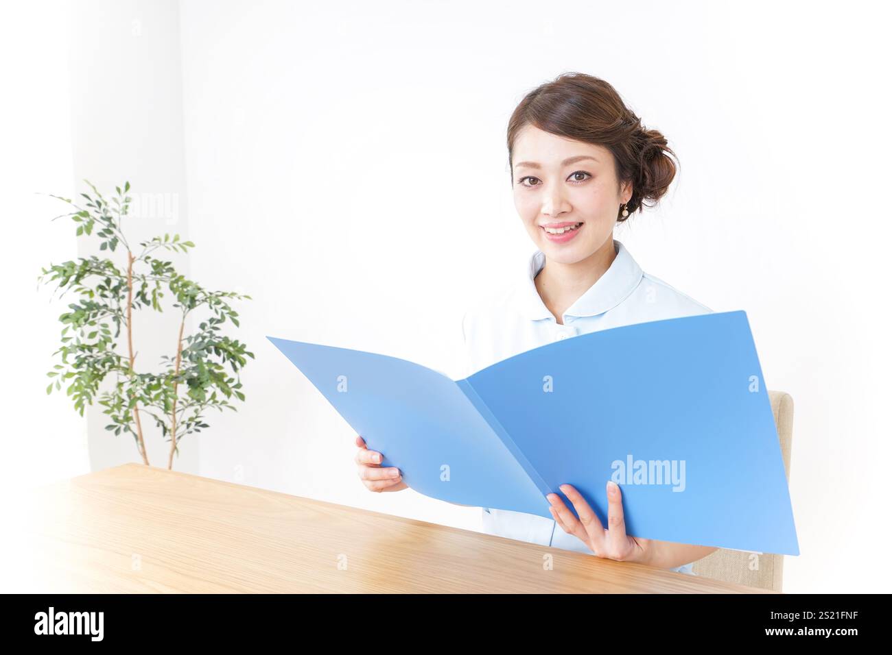 Nurse reading papers Stock Photo - Alamy
