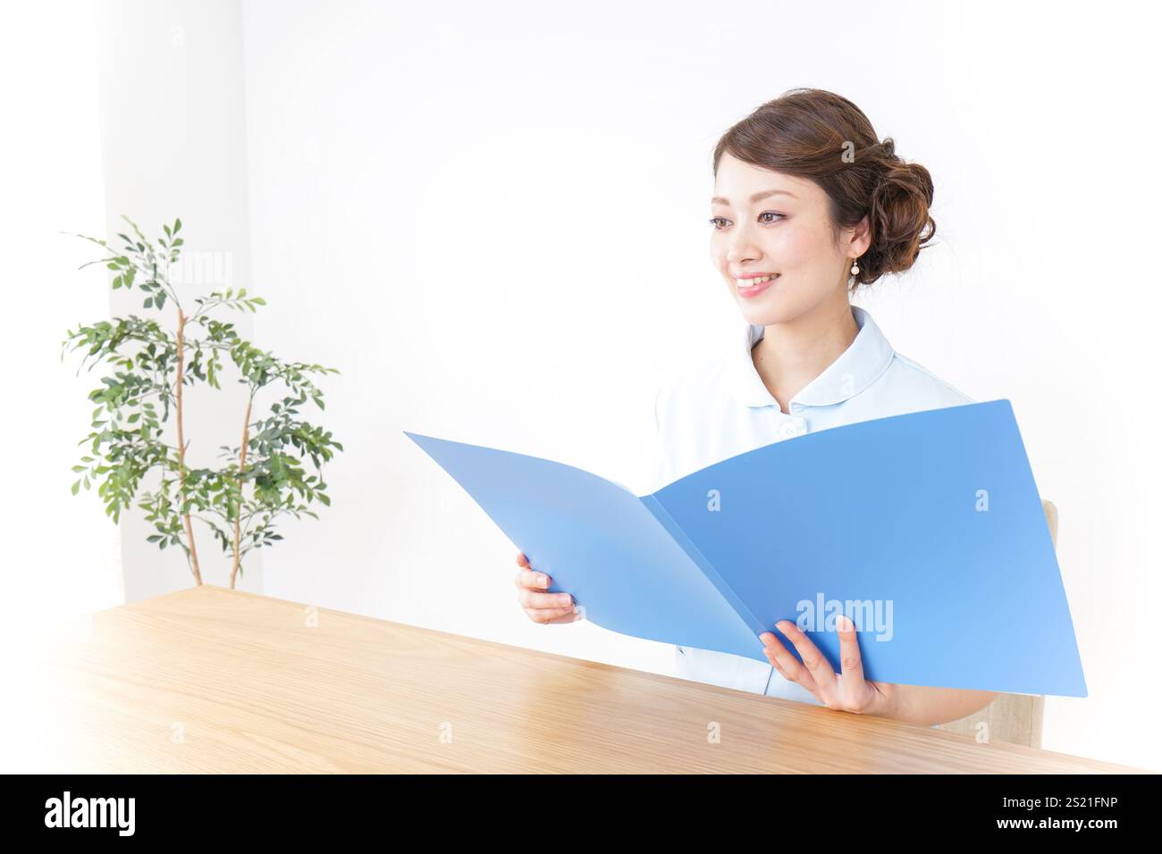 Nurse reading papers Stock Photo - Alamy