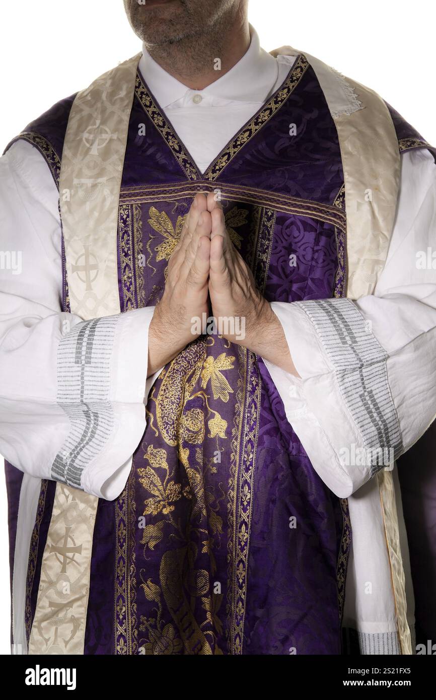 A Catholic priest praying during a church service Austria Stock Photo ...