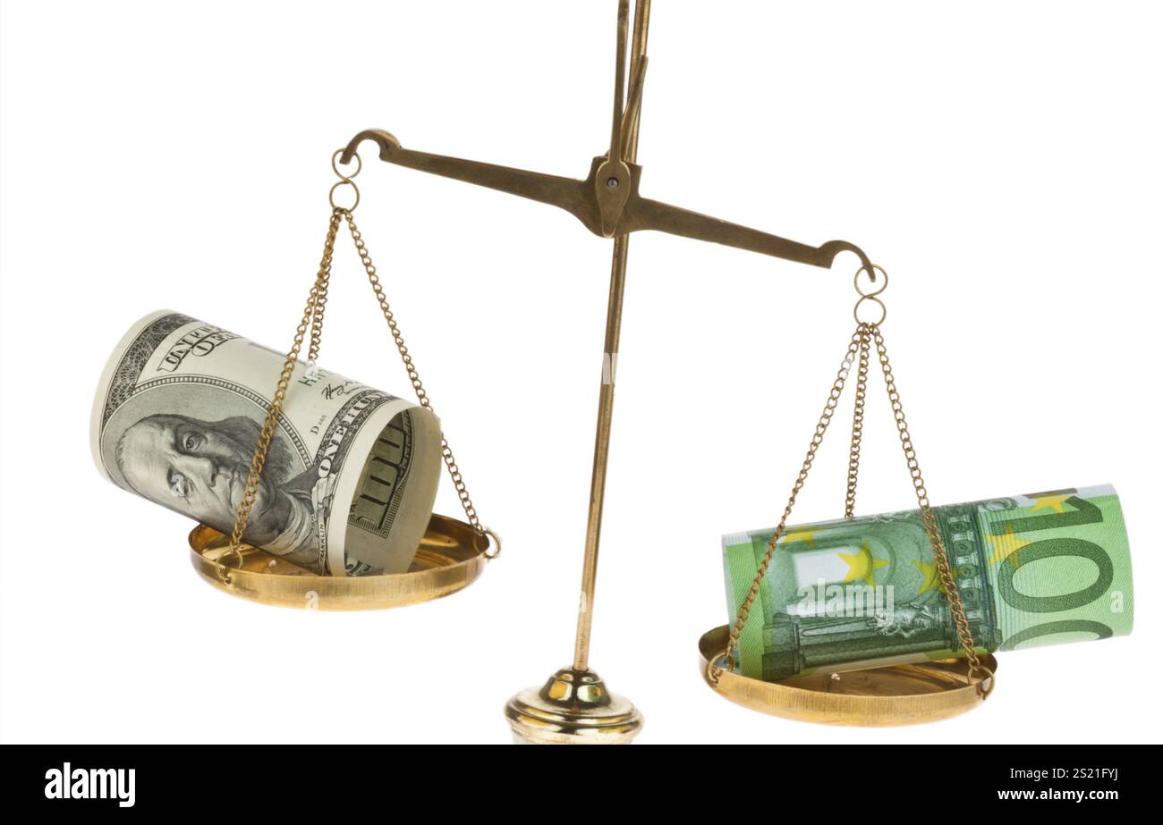 Euro banknotes and dollars on a scale against a white background ...