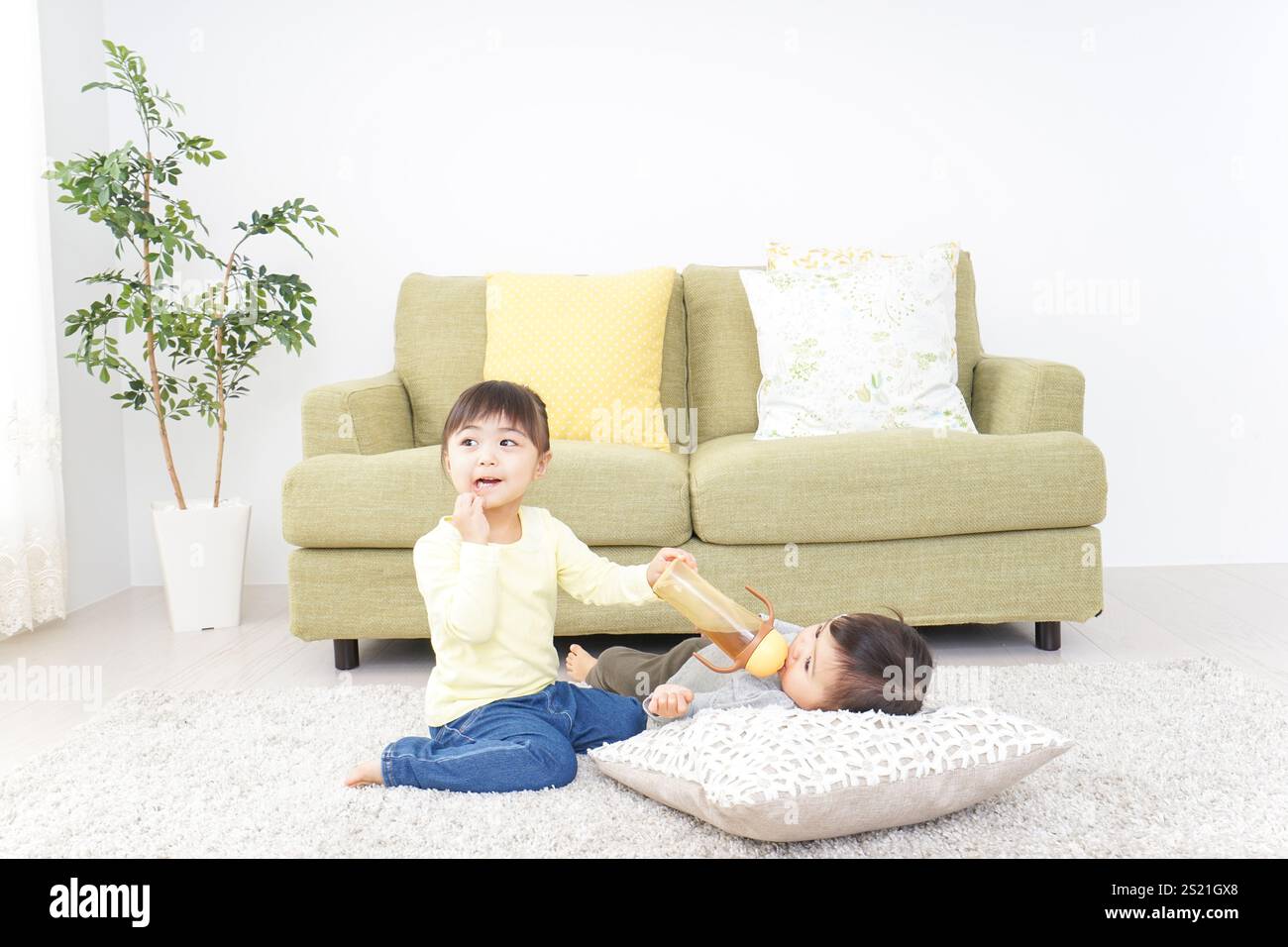 Child taking care of younger sister Stock Photo - Alamy