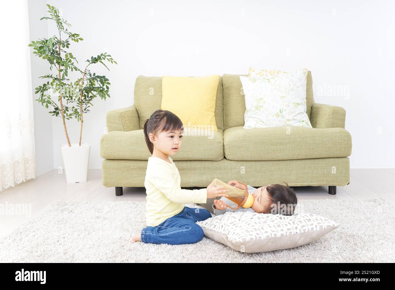 Child taking care of younger sister Stock Photo - Alamy