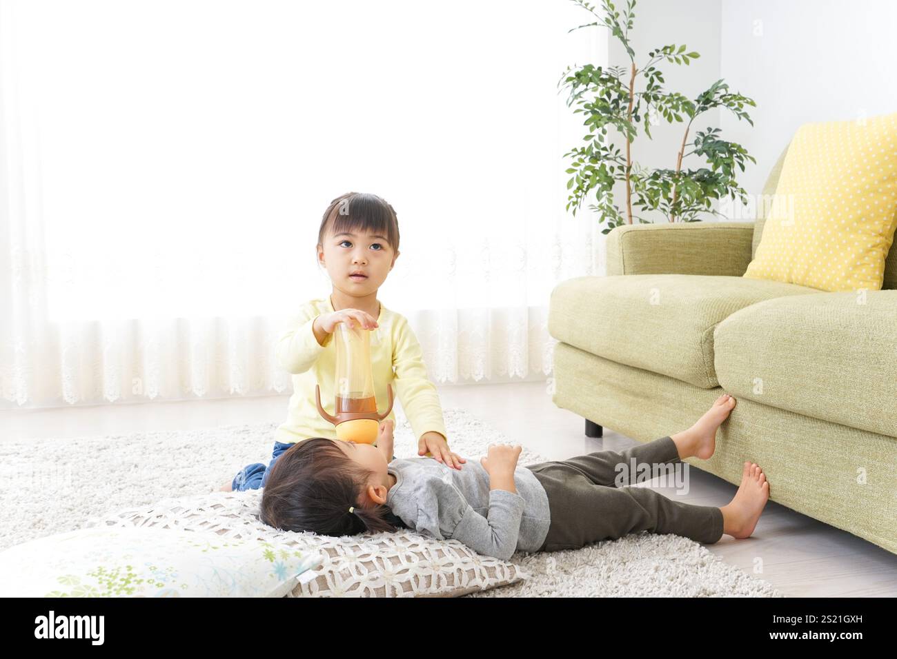 Child taking care of younger sister Stock Photo - Alamy