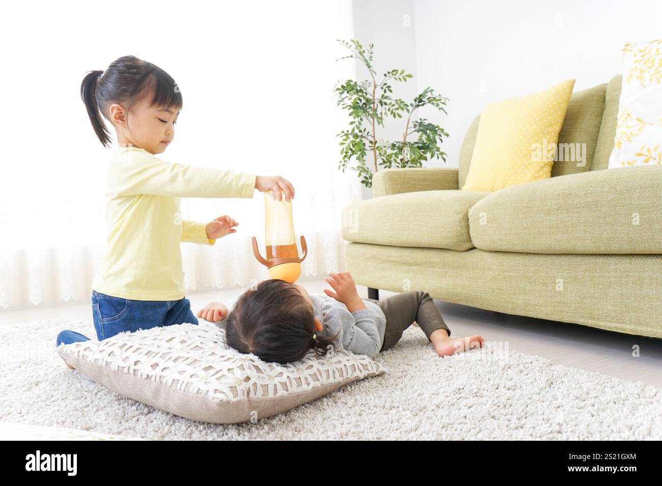 Child taking care of younger sister Stock Photo - Alamy