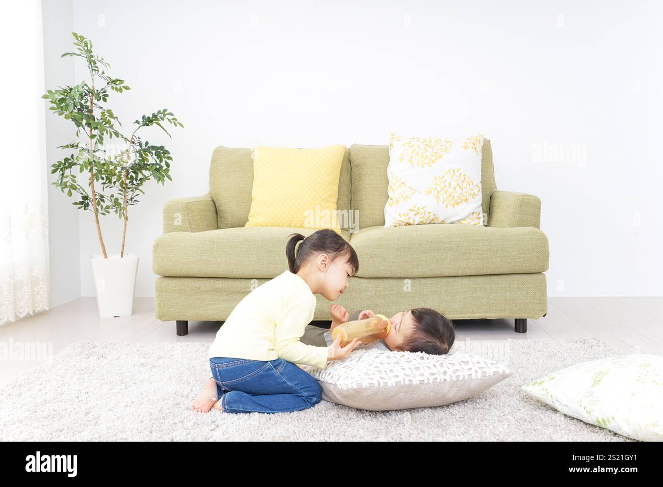 Child taking care of younger sister Stock Photo - Alamy