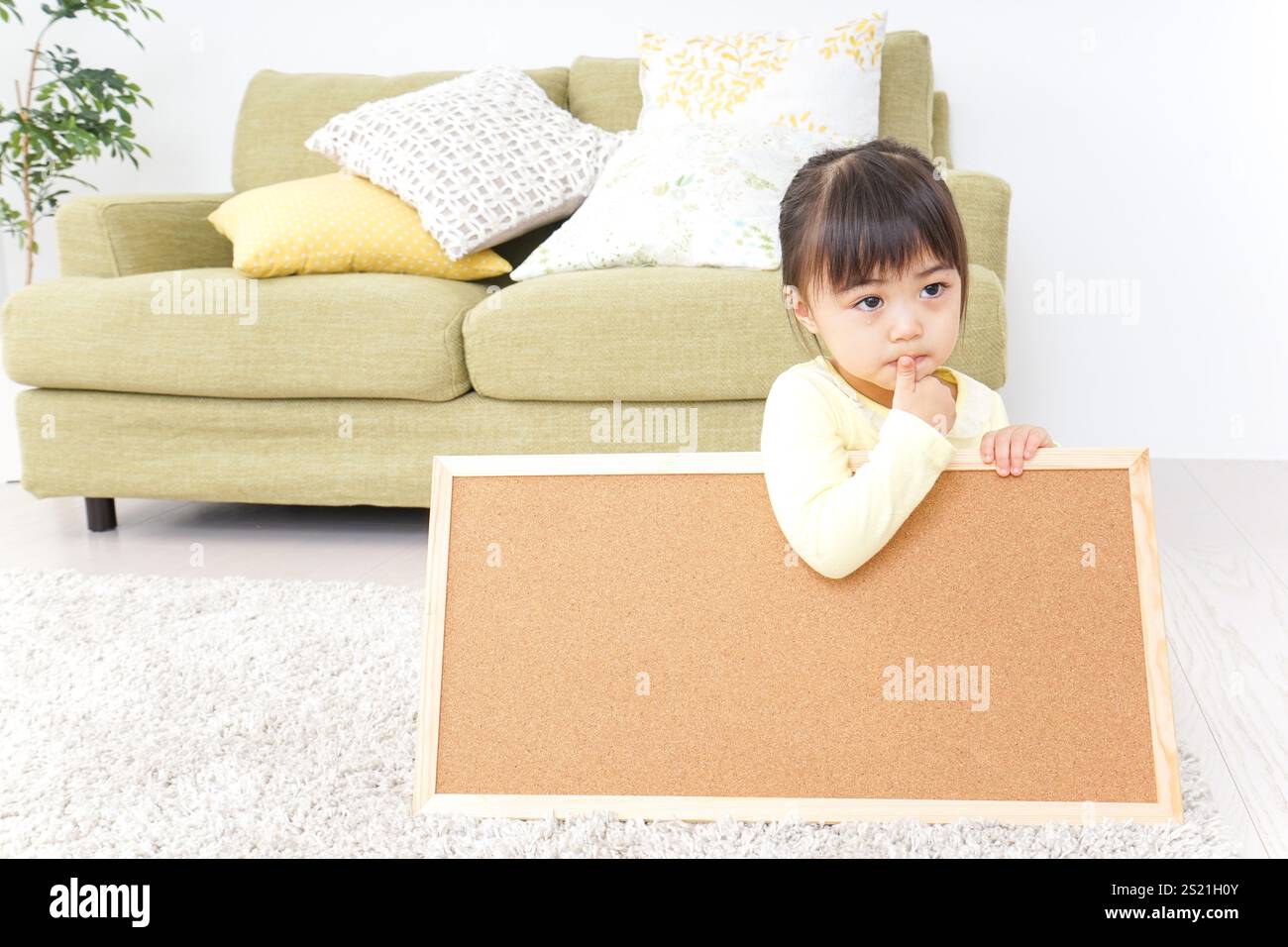 Crying child holding board Stock Photo - Alamy