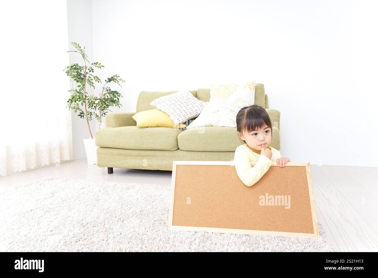 Crying child holding board Stock Photo - Alamy