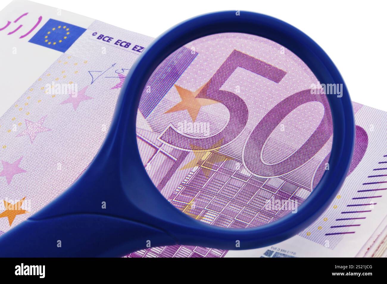 Many 500 euro banknotes lie in a pile. Seen through a magnifying glass ...
