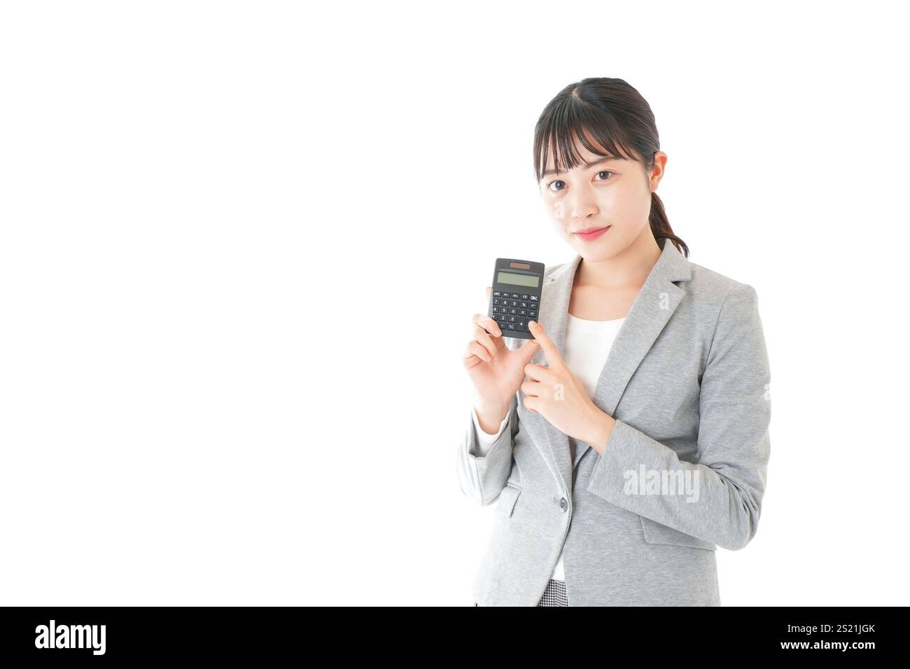 Young career woman doing calculations on a calculator Stock Photo - Alamy