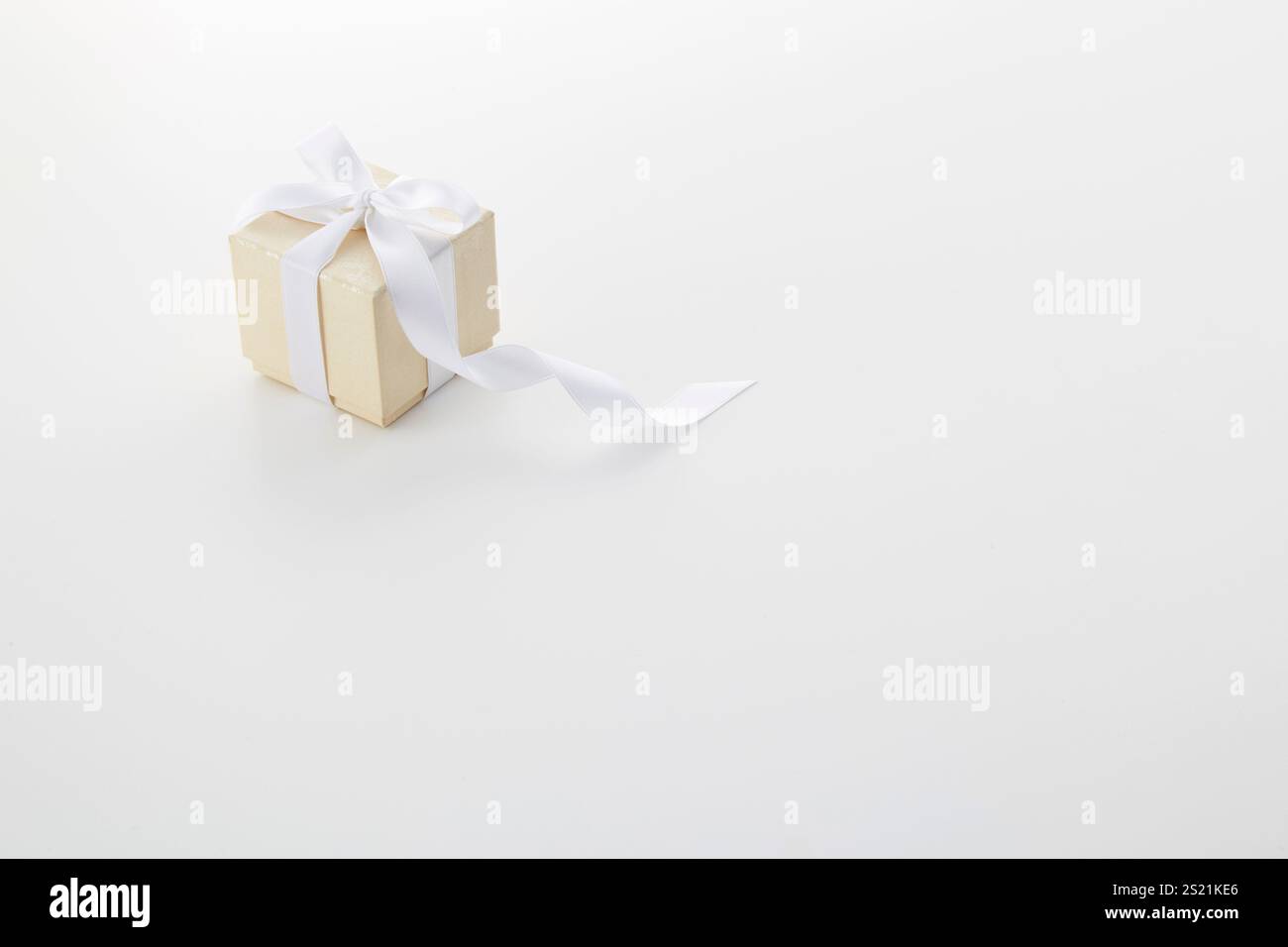Pretty little box with white ribbon Stock Photo - Alamy