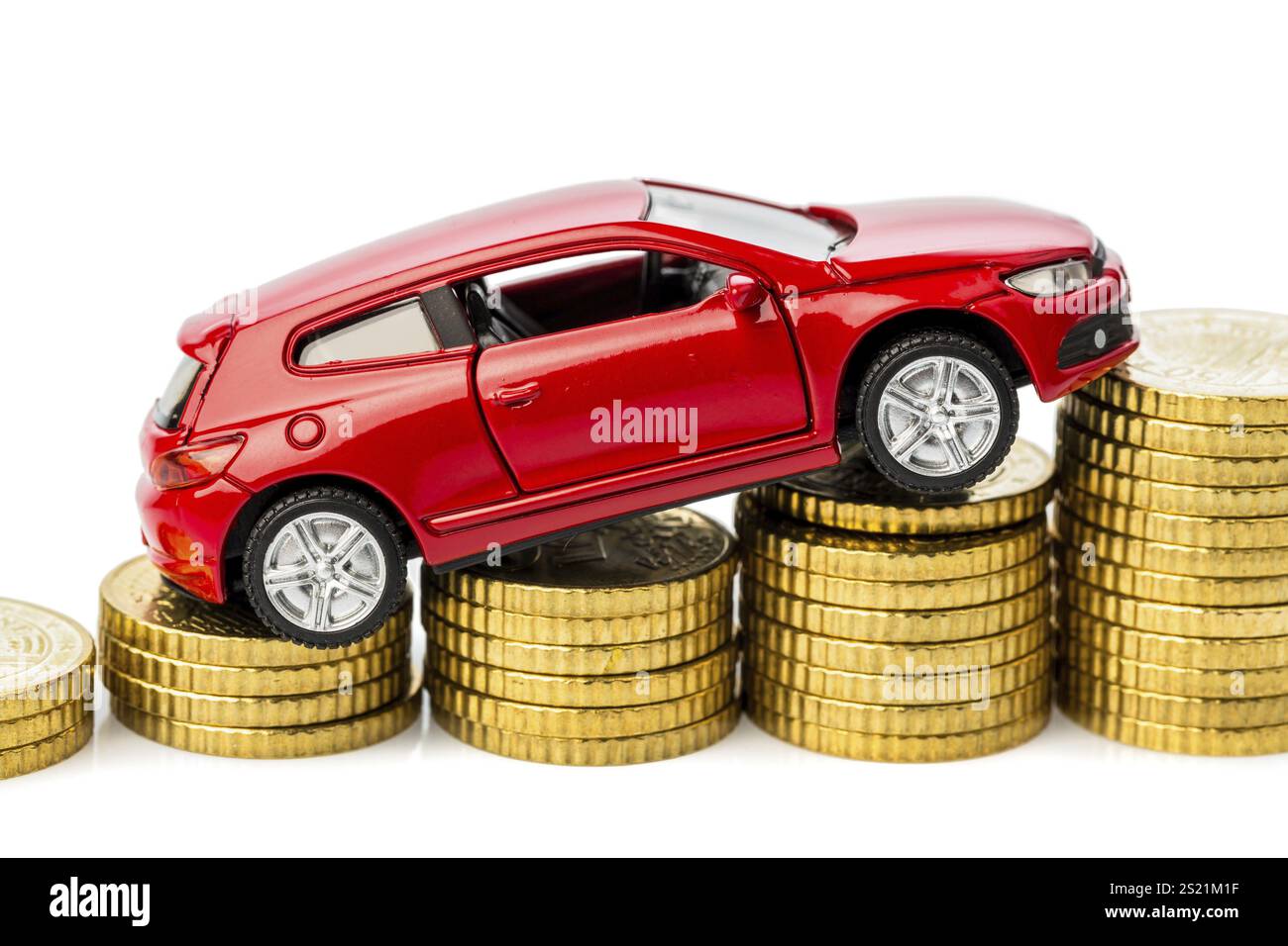 A car on coins. Symbolic photo for rising car costs for repairs and ...