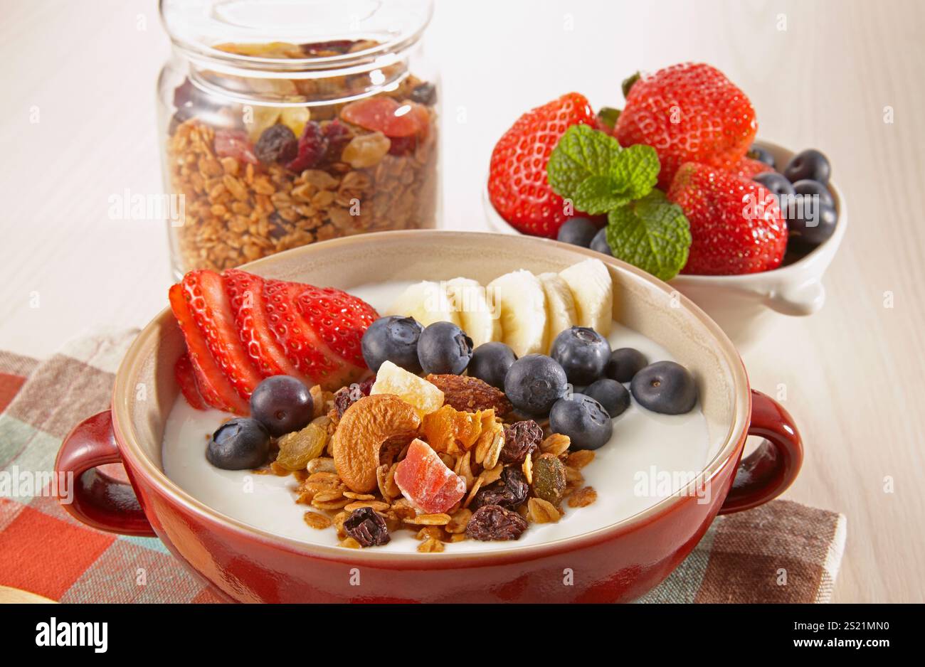 Fresh fruit-filled granola Stock Photo - Alamy