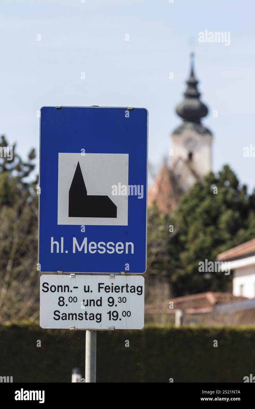 A sign announces the holy masses that are held in the parish church ...