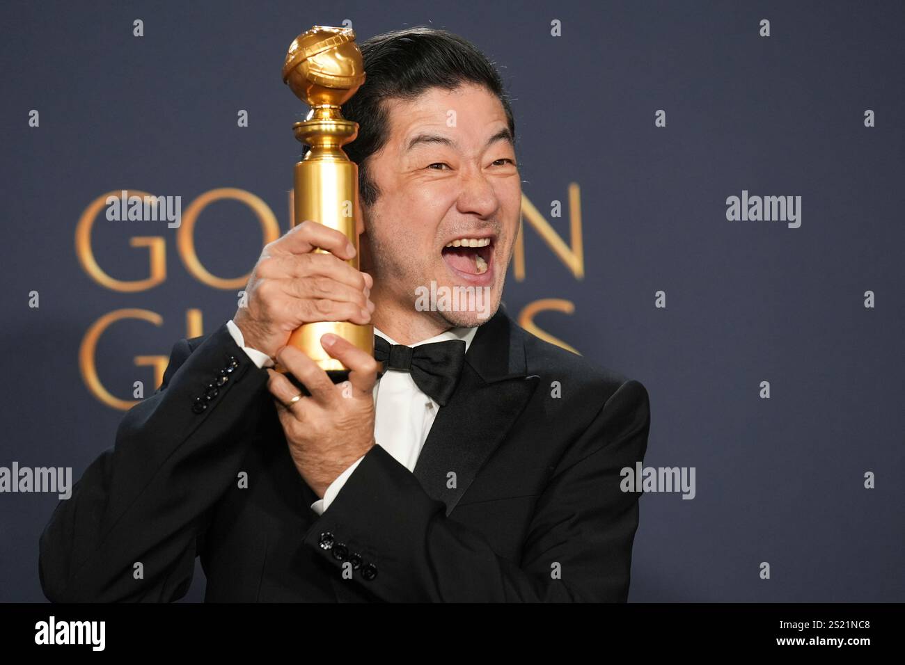 Tadanobu Asano poses in the press room with the award for best ...