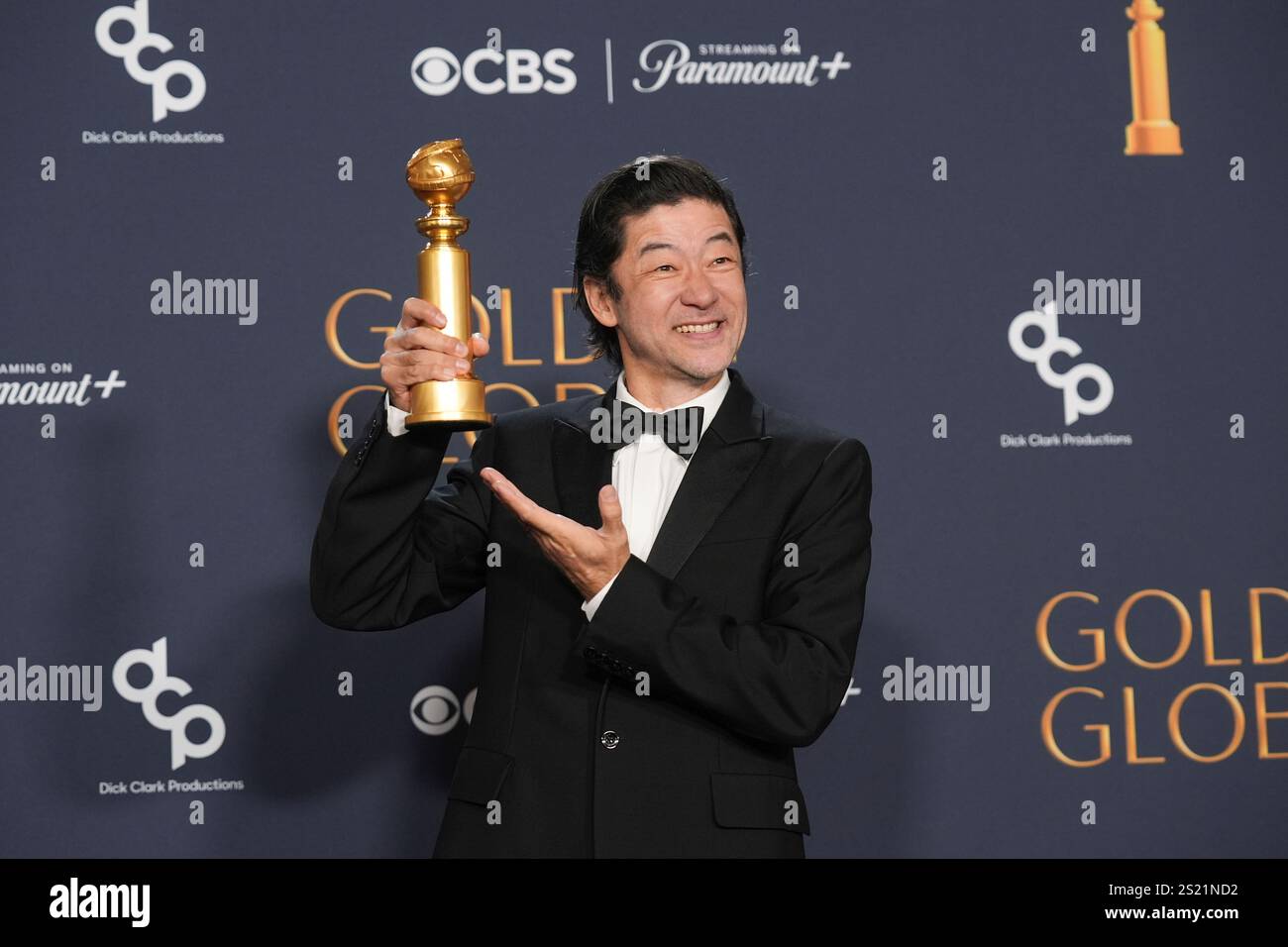 Tadanobu Asano poses in the press room with the award for best performance by a male actor in a ...