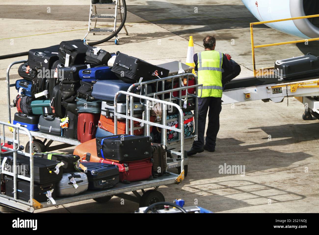 Many suitcases. Luggage being loaded onto an aeroplane. Luggage and ...